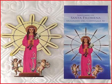 Wooden statue of St. Philomena with prayer